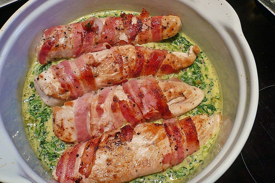 Chicken breast fillet wrapped in bacon on a bed of spinach | Chef Reader
